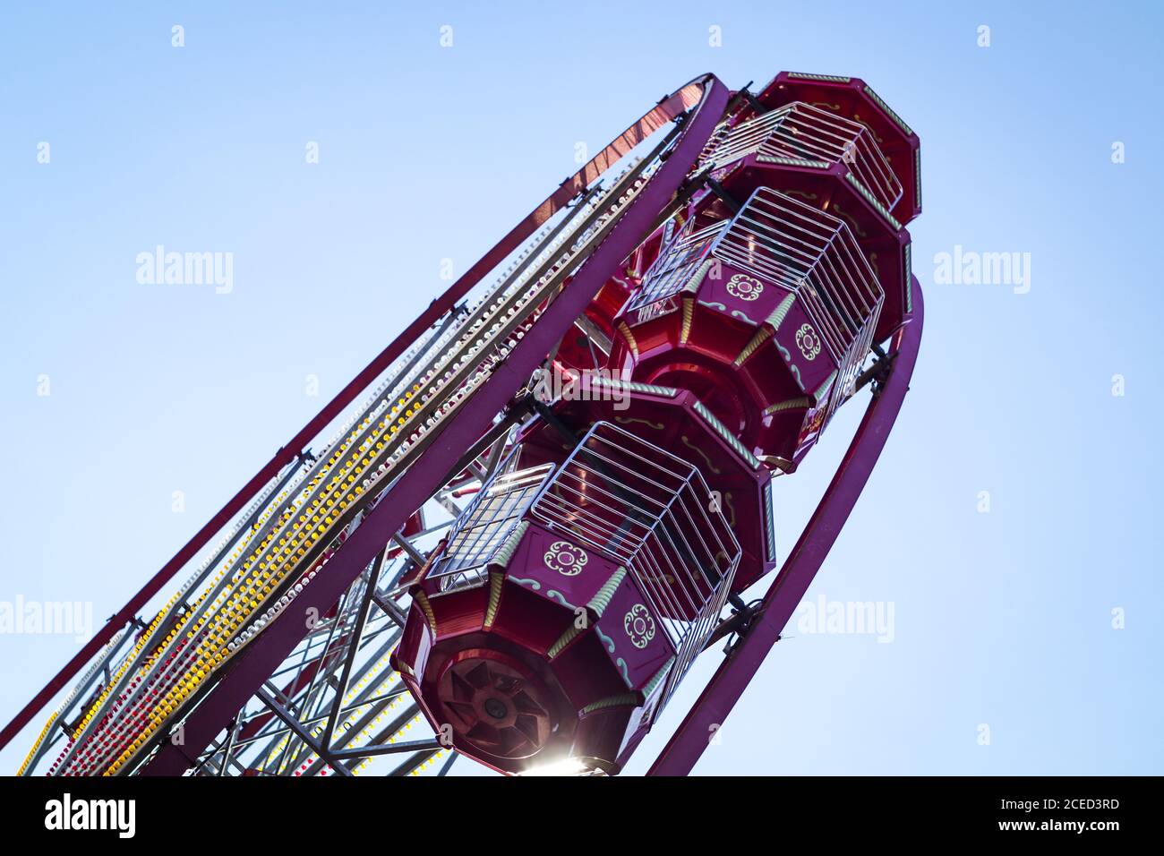 Vintage red big wheel fairground blue sky copy space top left bottom ...