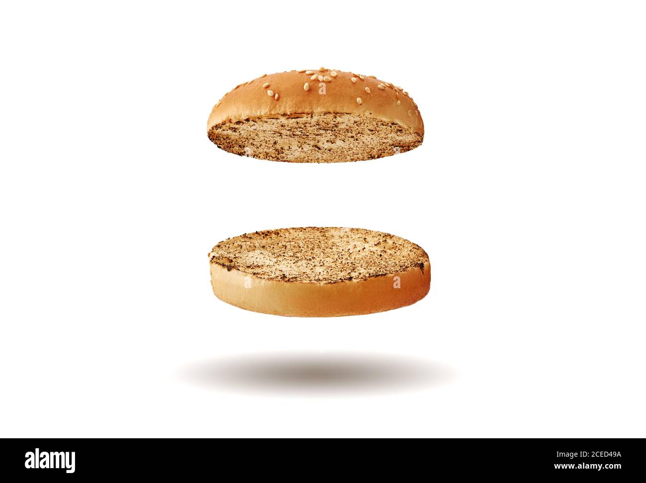 Flying, baked or grilled, cut in half burger bun sprinkled with sesame ...