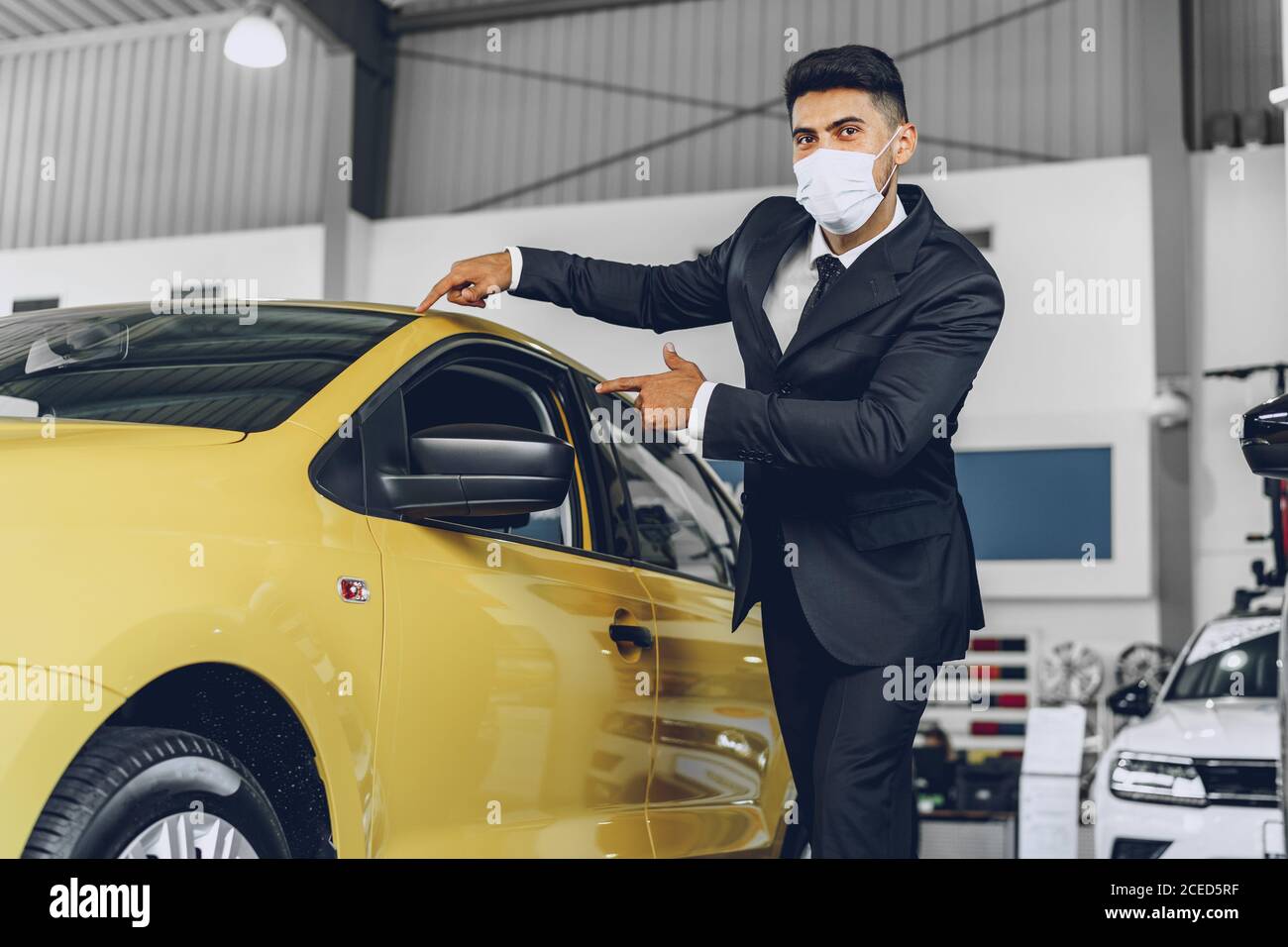 Man car dealer wearing protective medical mask on his working place ...