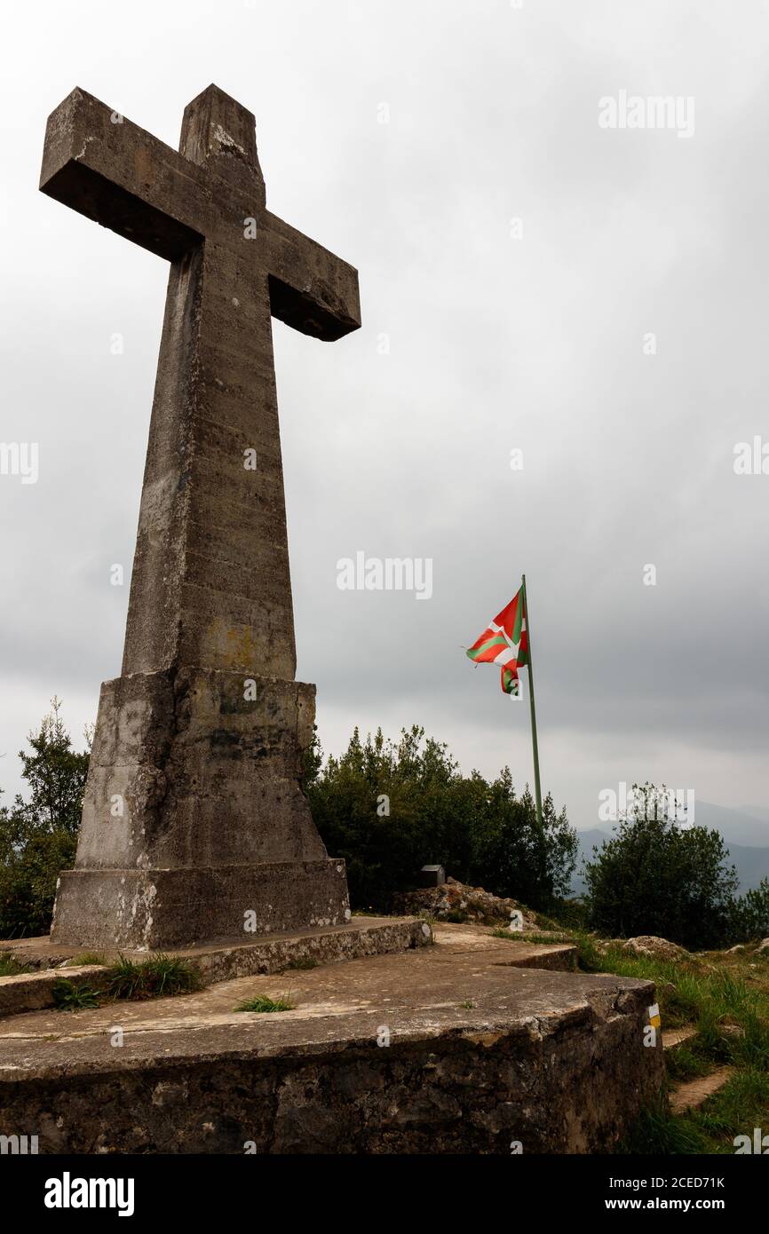 Vertical shot of a big cross in the mountains of Basque country on a ...