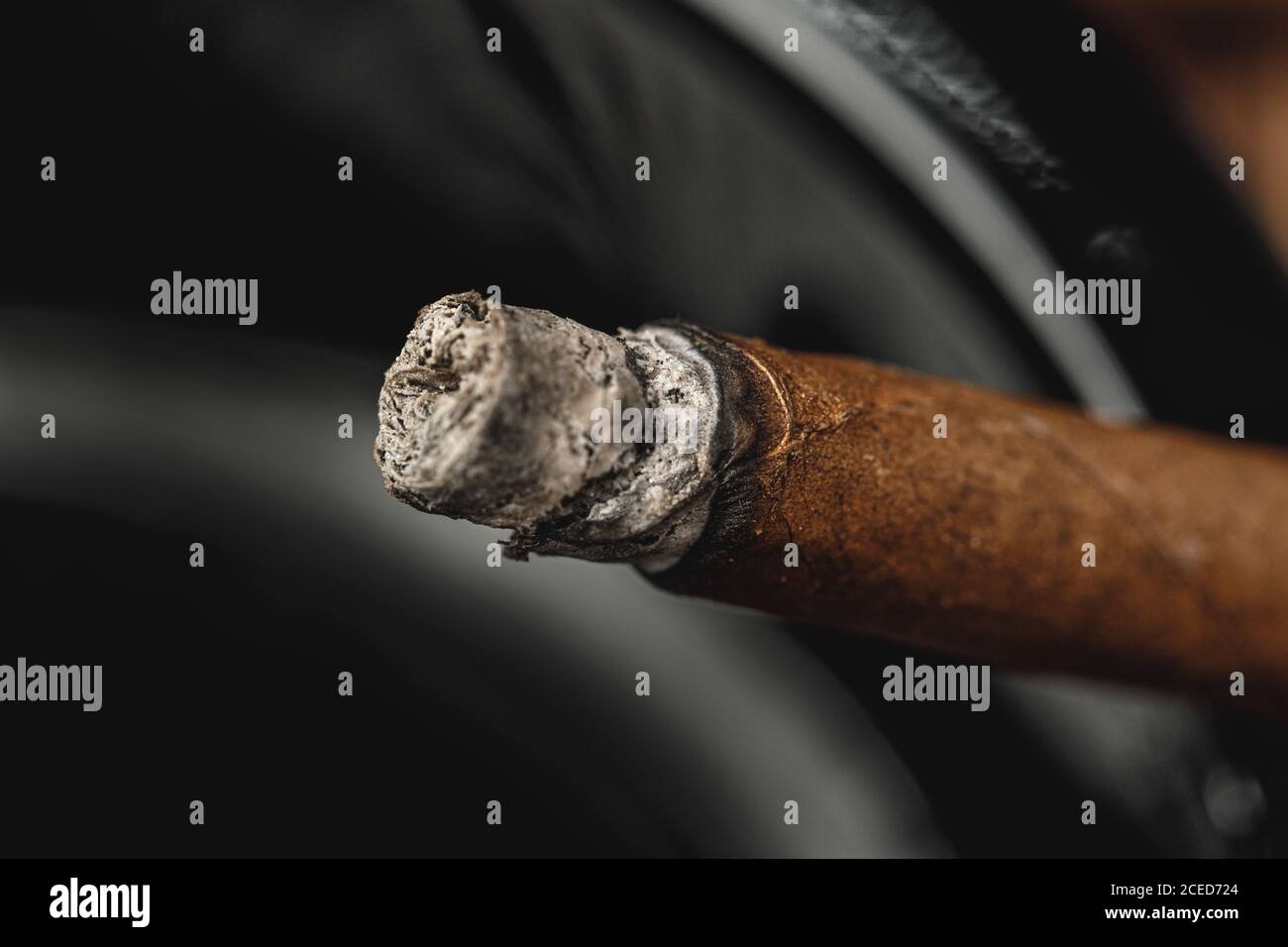 Lighted cigar in an ashtray close up Stock Photo - Alamy
