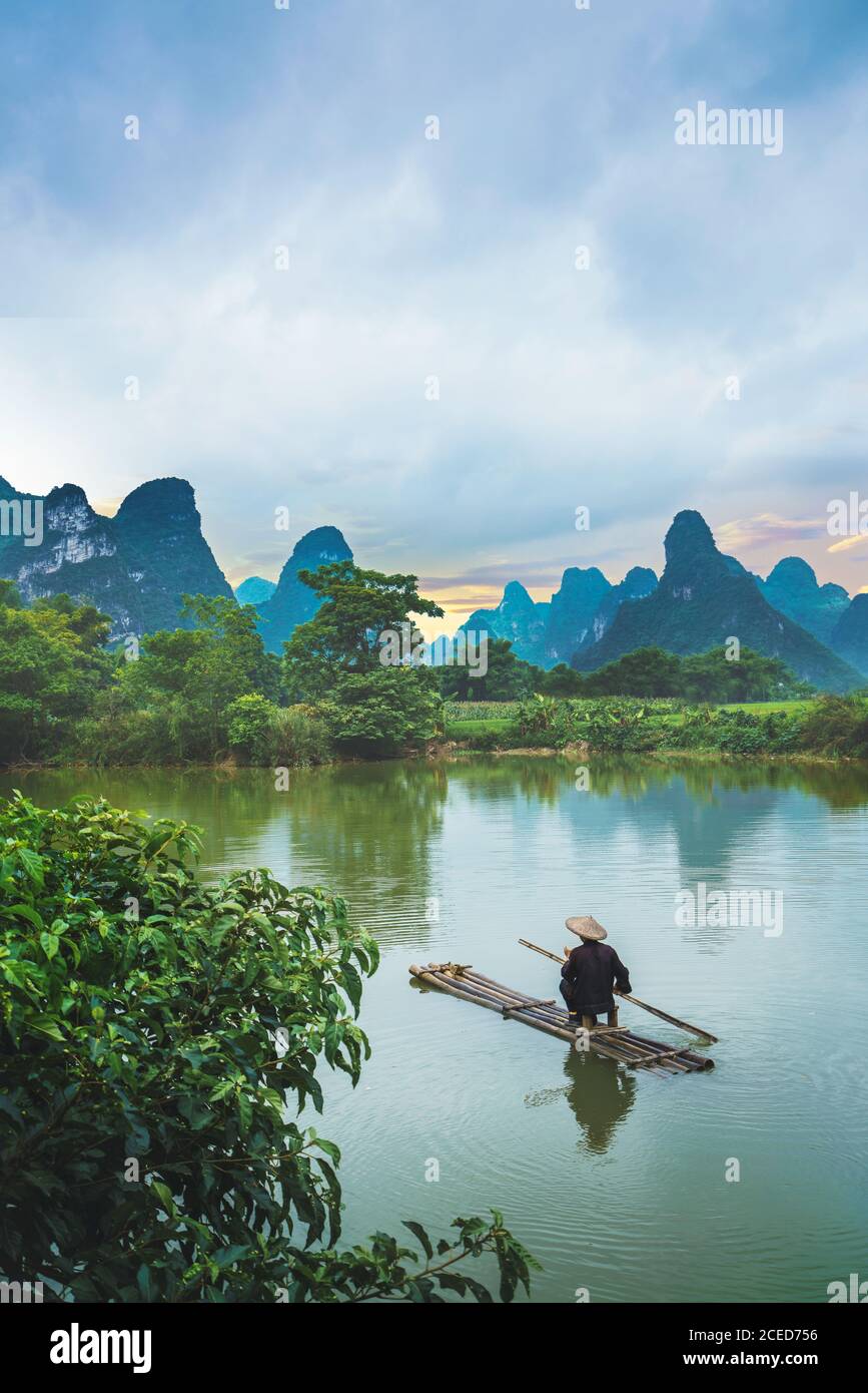 Chinese man sitting on raft on Quây Son Stock Photo - Alamy