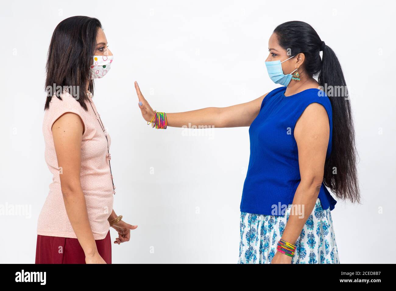 Two pretty Indian women wearing Covid-19 protection mask. Two females ...