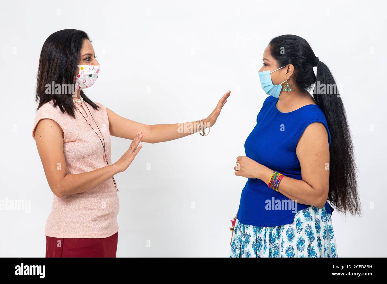 Two pretty Indian women wearing Covid-19 protection mask. Two females ...