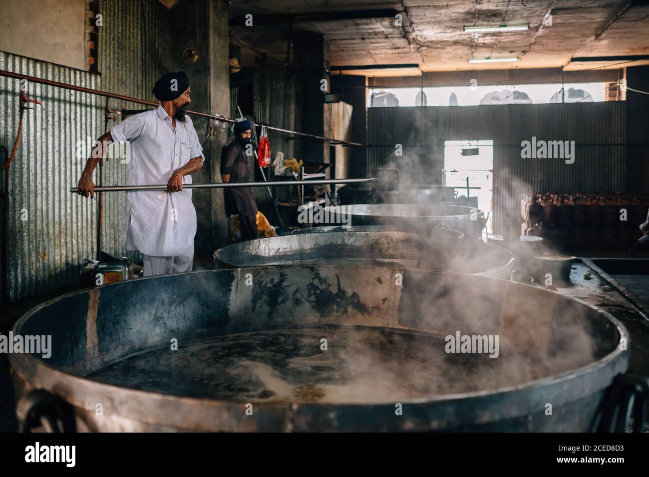 Amritsar, India - AUGUST 15: Cooks preparing food portion for pilgrims ...