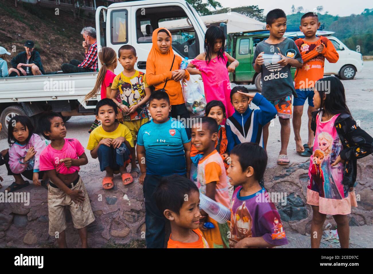 Group of cheerful Asian kids having fun and standing at trucks Stock ...