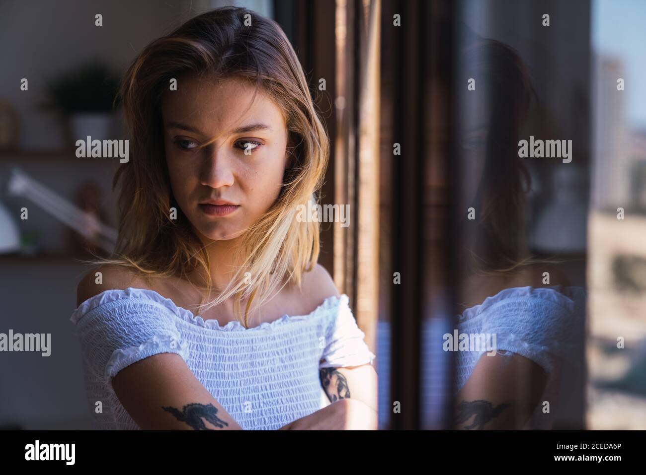 Pretty Woman posing near window Stock Photo - Alamy