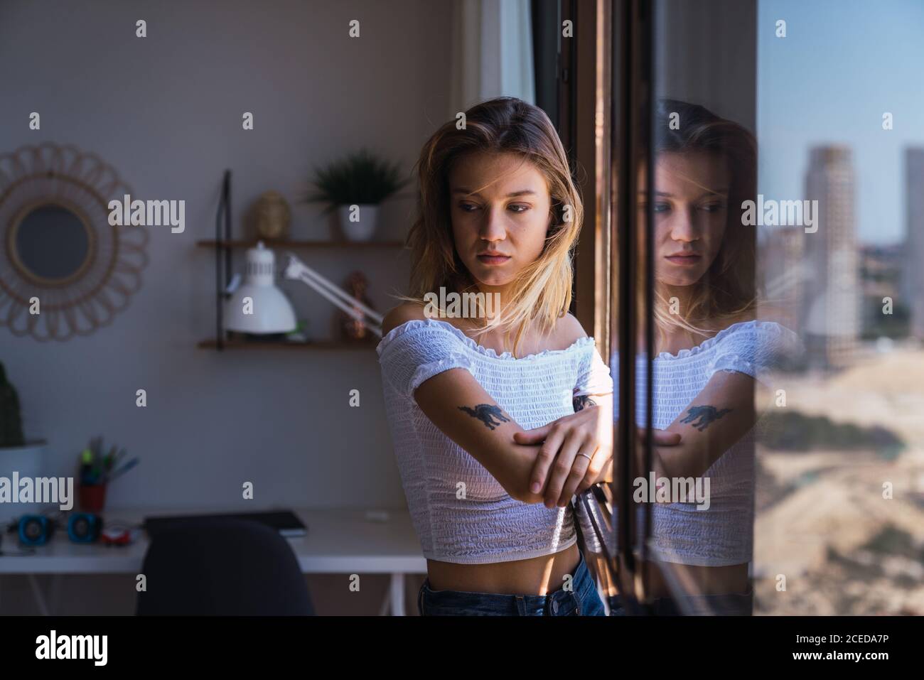 Pretty Woman posing near window Stock Photo - Alamy