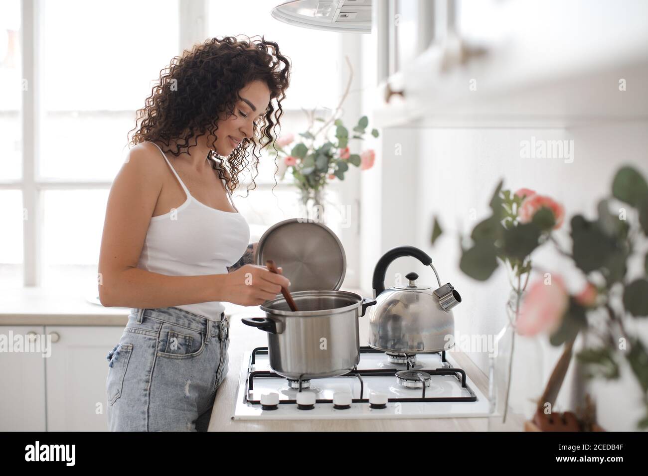 beautiful woman cooking soup at home in kitchen Stock Photo - Alamy