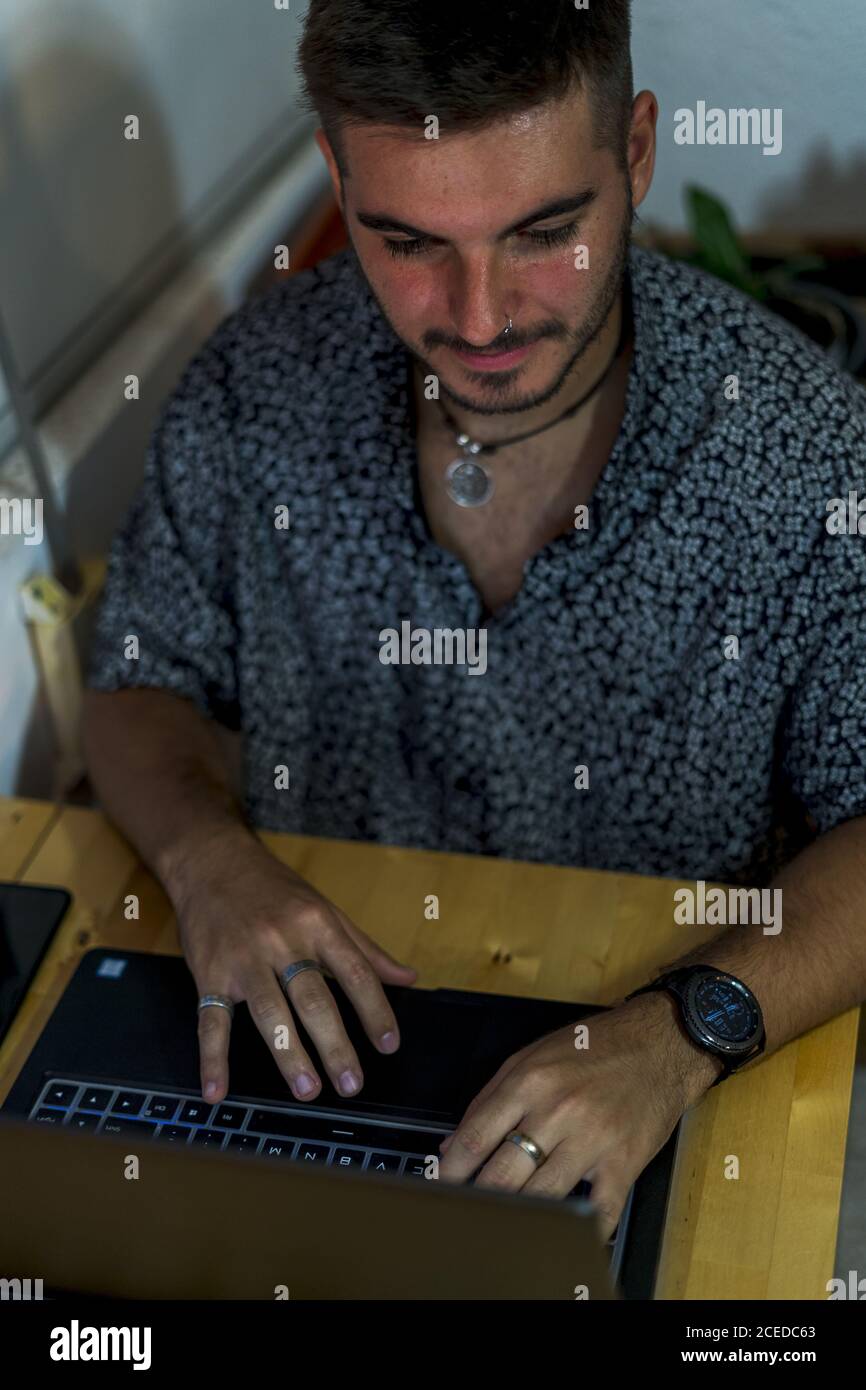 Vertical shot of a European male working with a laptop at home Stock ...