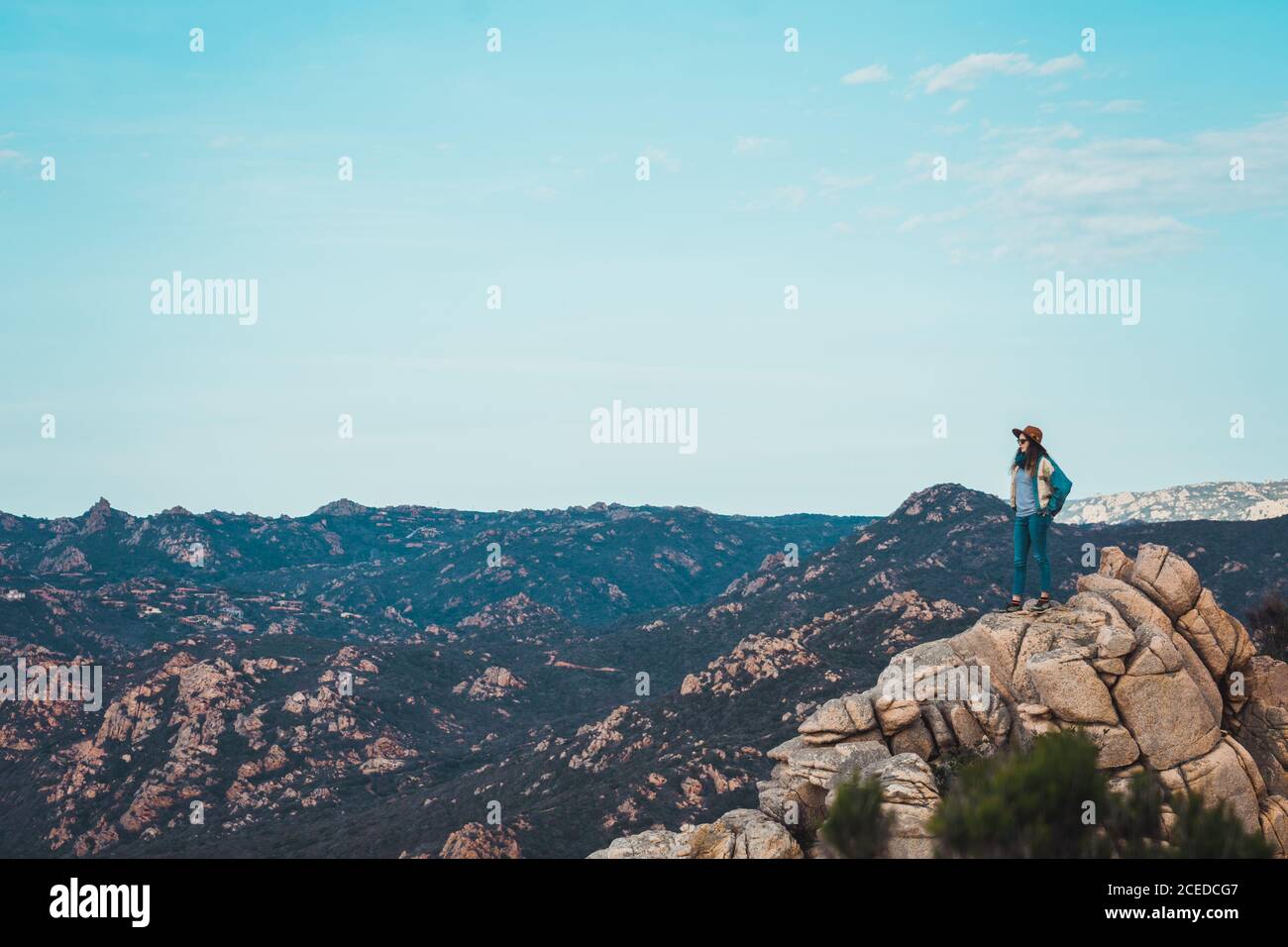 Woman on rock at the ocean Stock Photo - Alamy