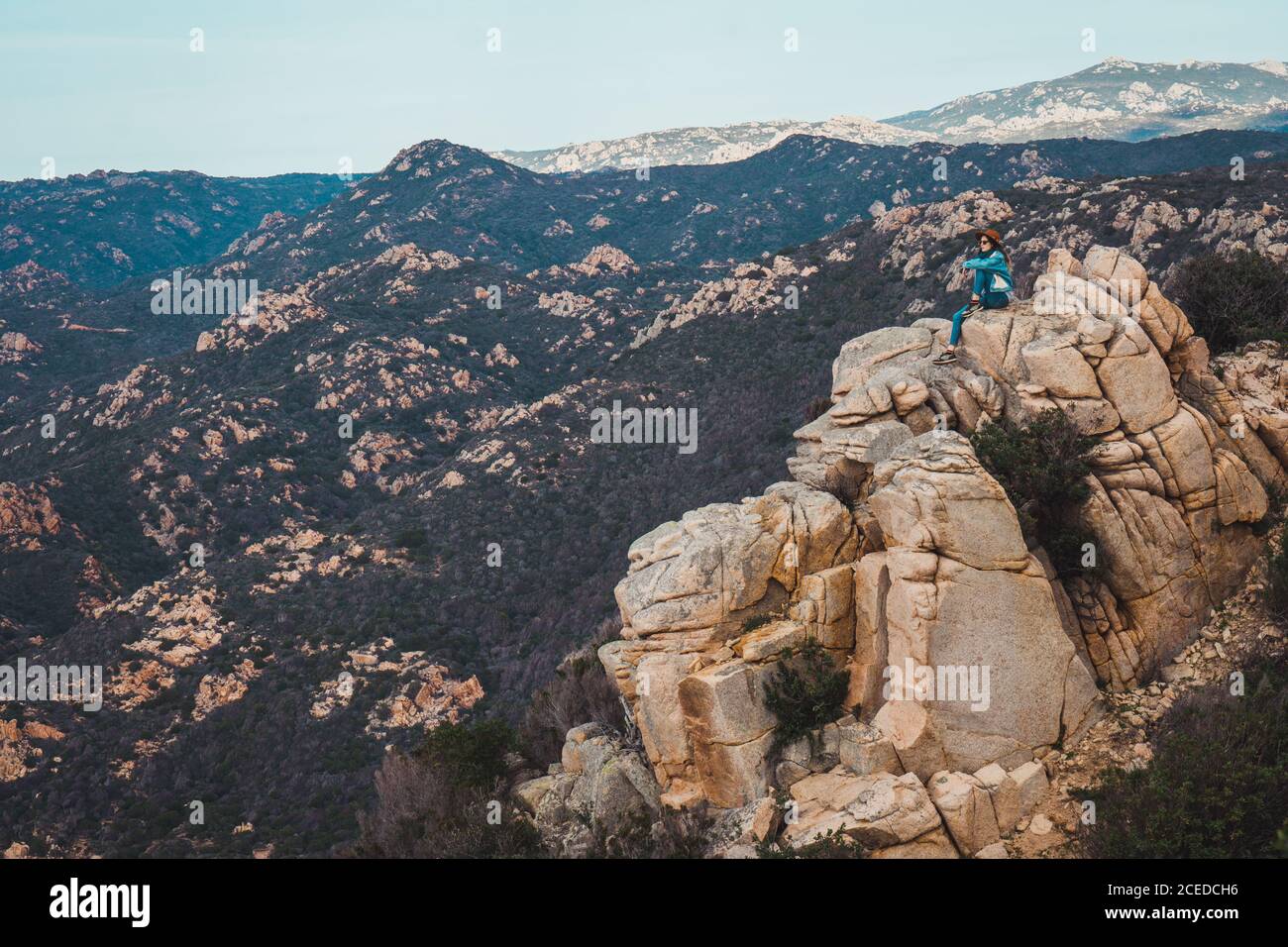 Woman on rock at the ocean Stock Photo - Alamy
