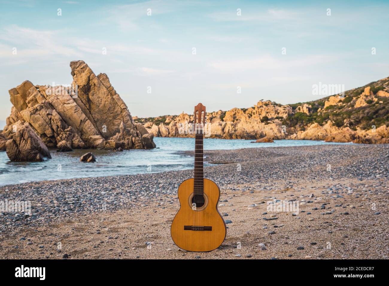 Classic acoustic guitar placed on sandy beach at the ocean Stock Photo ...