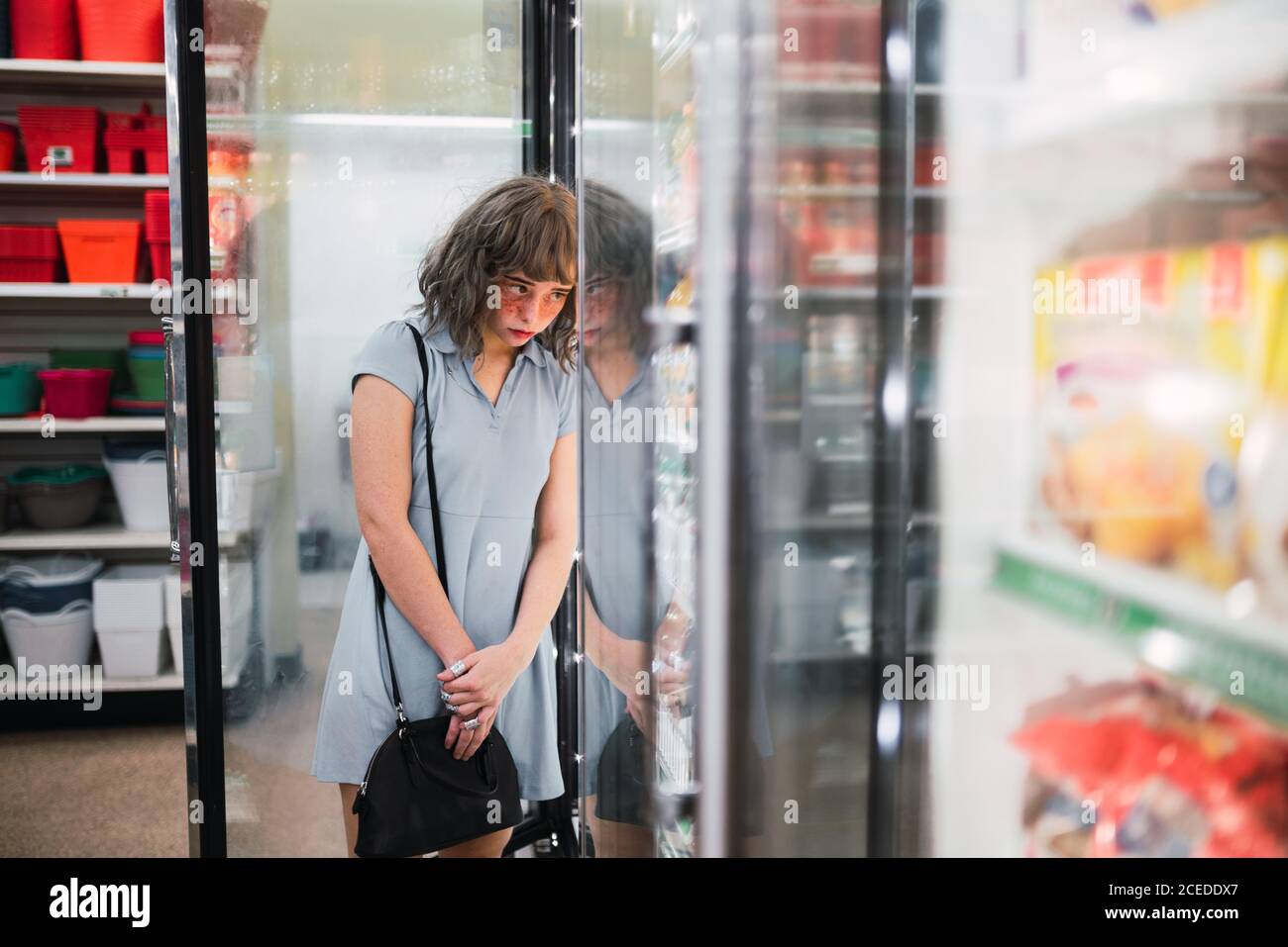 Young Woman with gray hair puffing cheeks and keeping eyes closed while ...