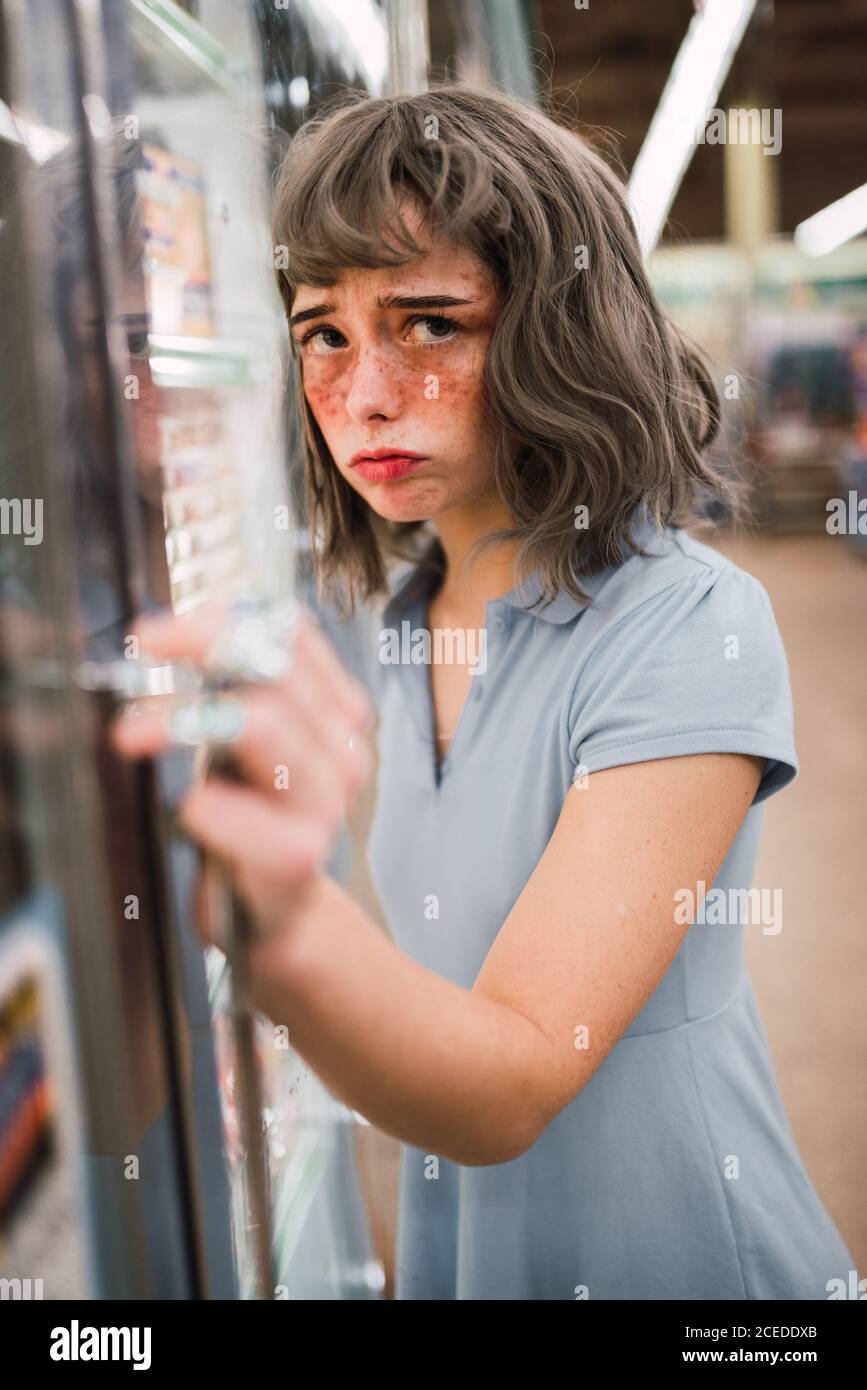 Young Woman with gray hair puffing cheeks and keeping eyes closed while ...