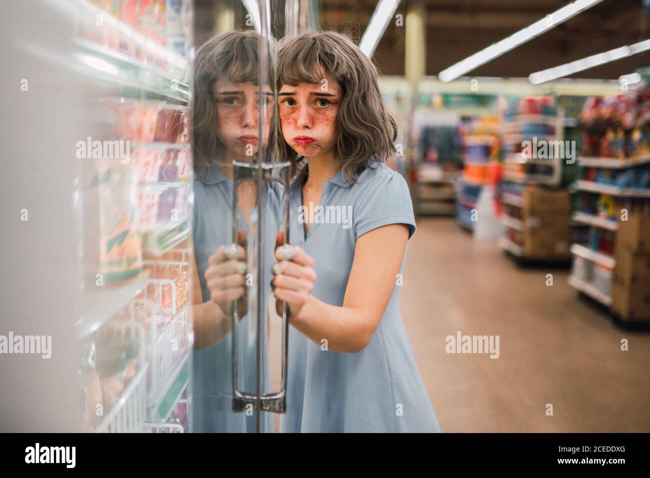 Young Woman with gray hair puffing cheeks and keeping eyes closed while ...