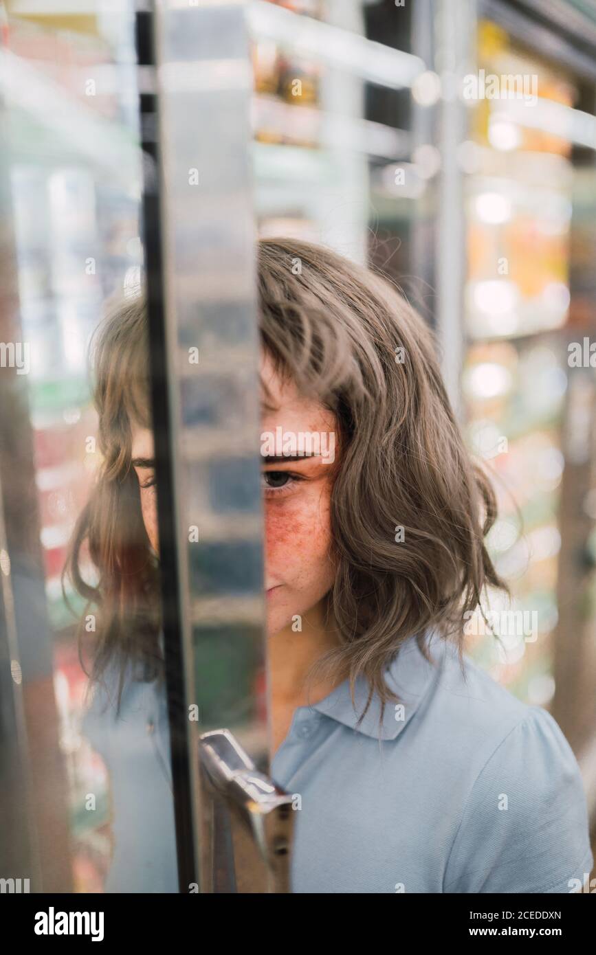 Young Woman with gray hair puffing cheeks and keeping eyes closed while ...