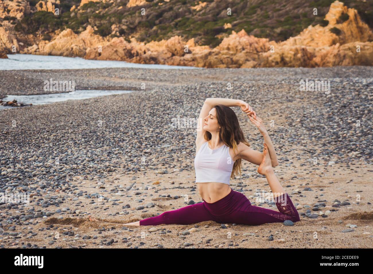 Woman in string pose on shore Stock Photo - Alamy
