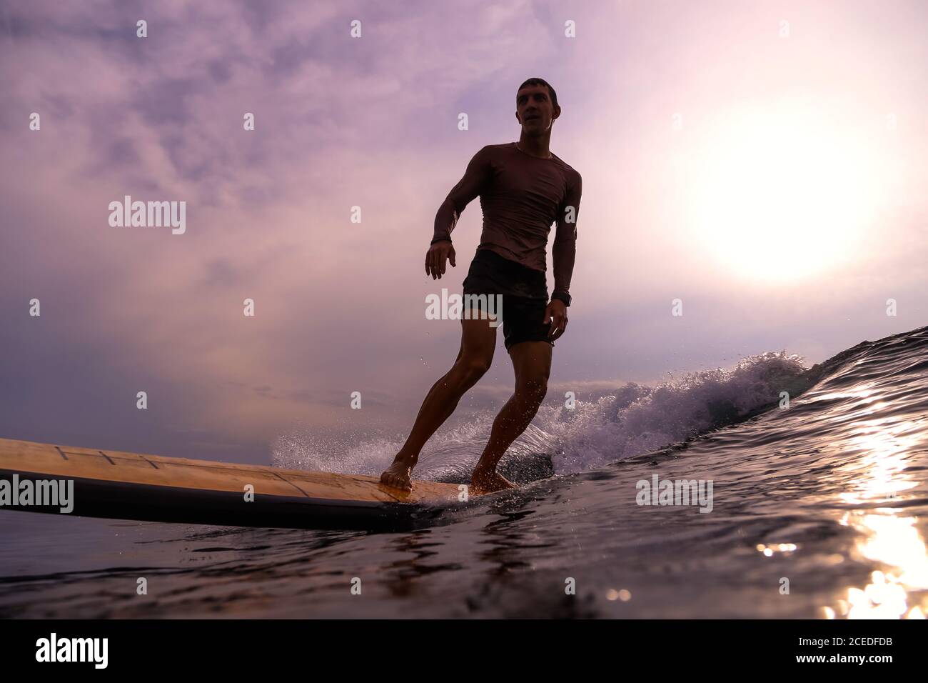 Ground level side view of slim female sitting on mat in Vajrasana ...