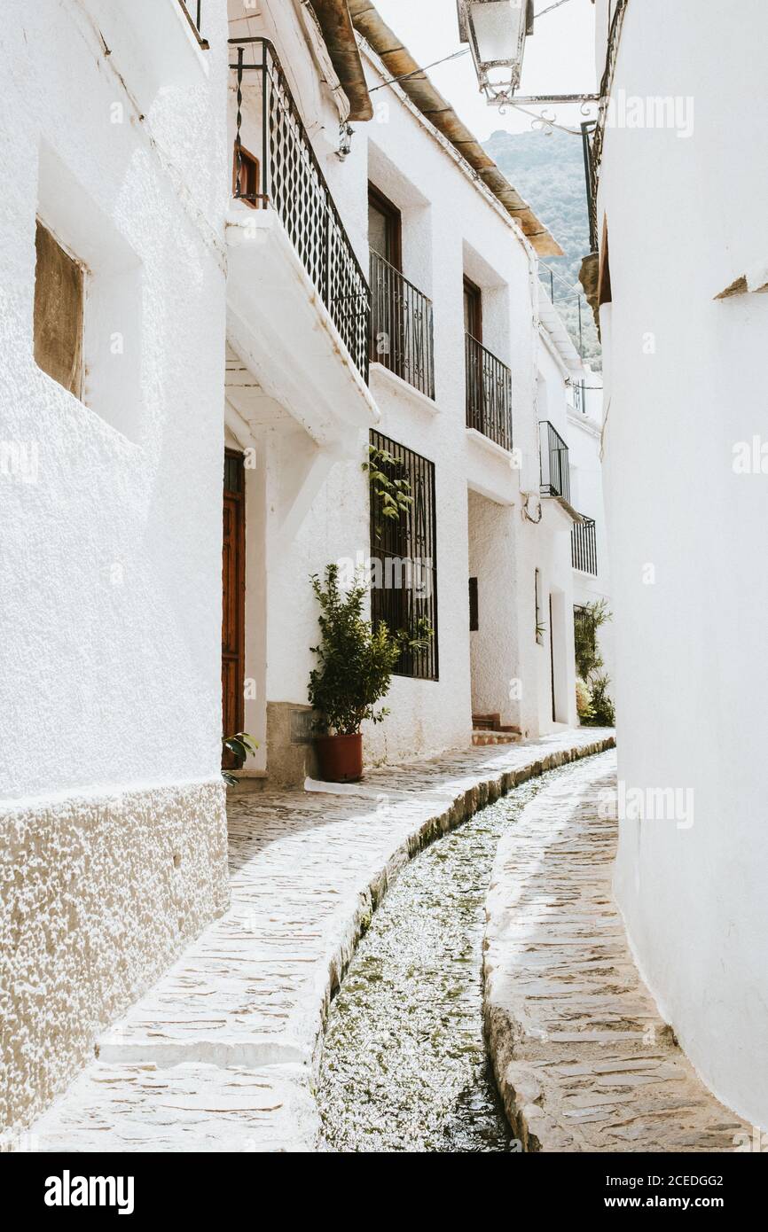 Small water channel going through narrow ancient street on sunny day in ...