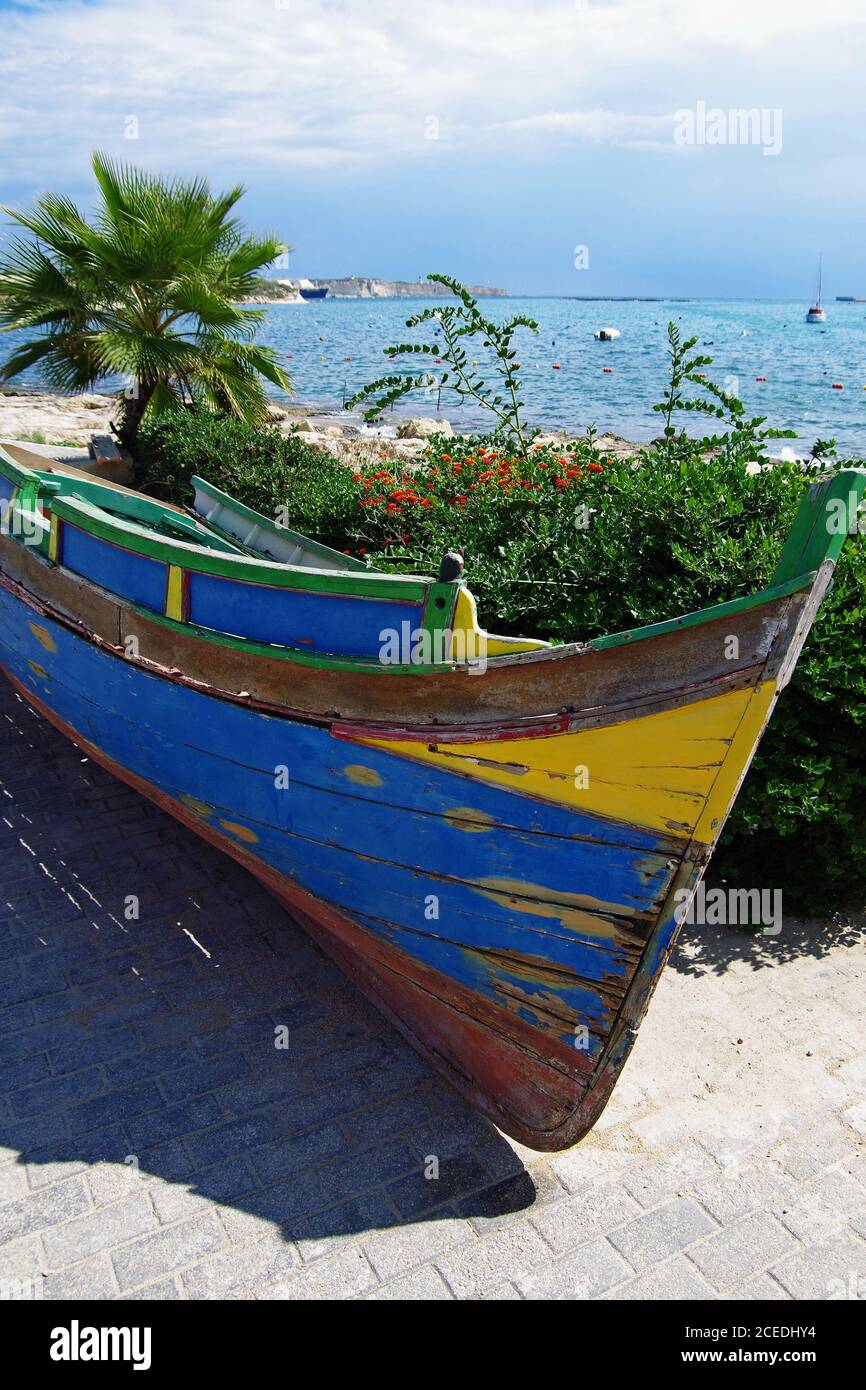 Maltese Luzzu traditional fishing boat on the beach, Malta Stock Photo ...