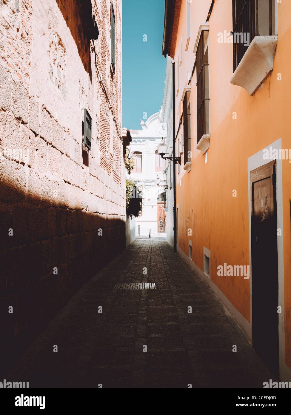 Narrow stone path going among amazing houses on street of Merida, Spain ...