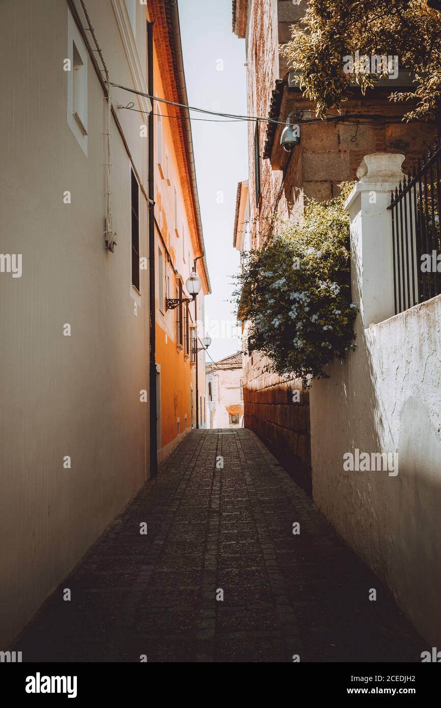 Narrow stone path going among amazing houses on street of Merida, Spain ...