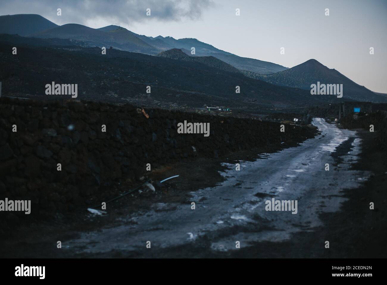 Landscape wet remote road rocky dark terrain silhouette mountains hi ...