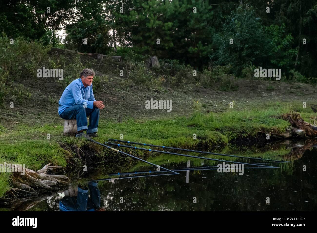 Man sitting on lake shore hi-res stock photography and images - Alamy