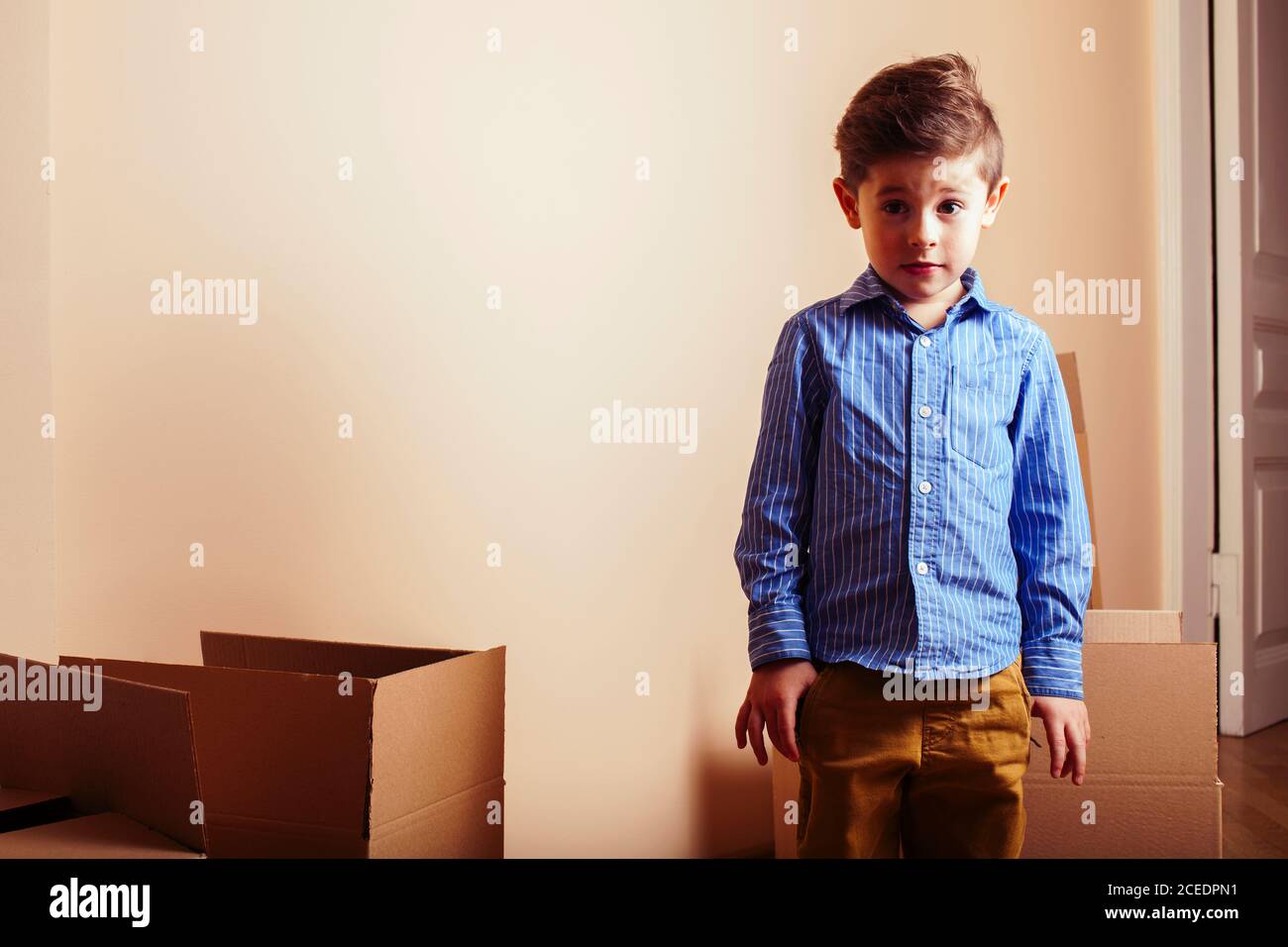 little cute boy in empty room, move to new house. home alone among ...