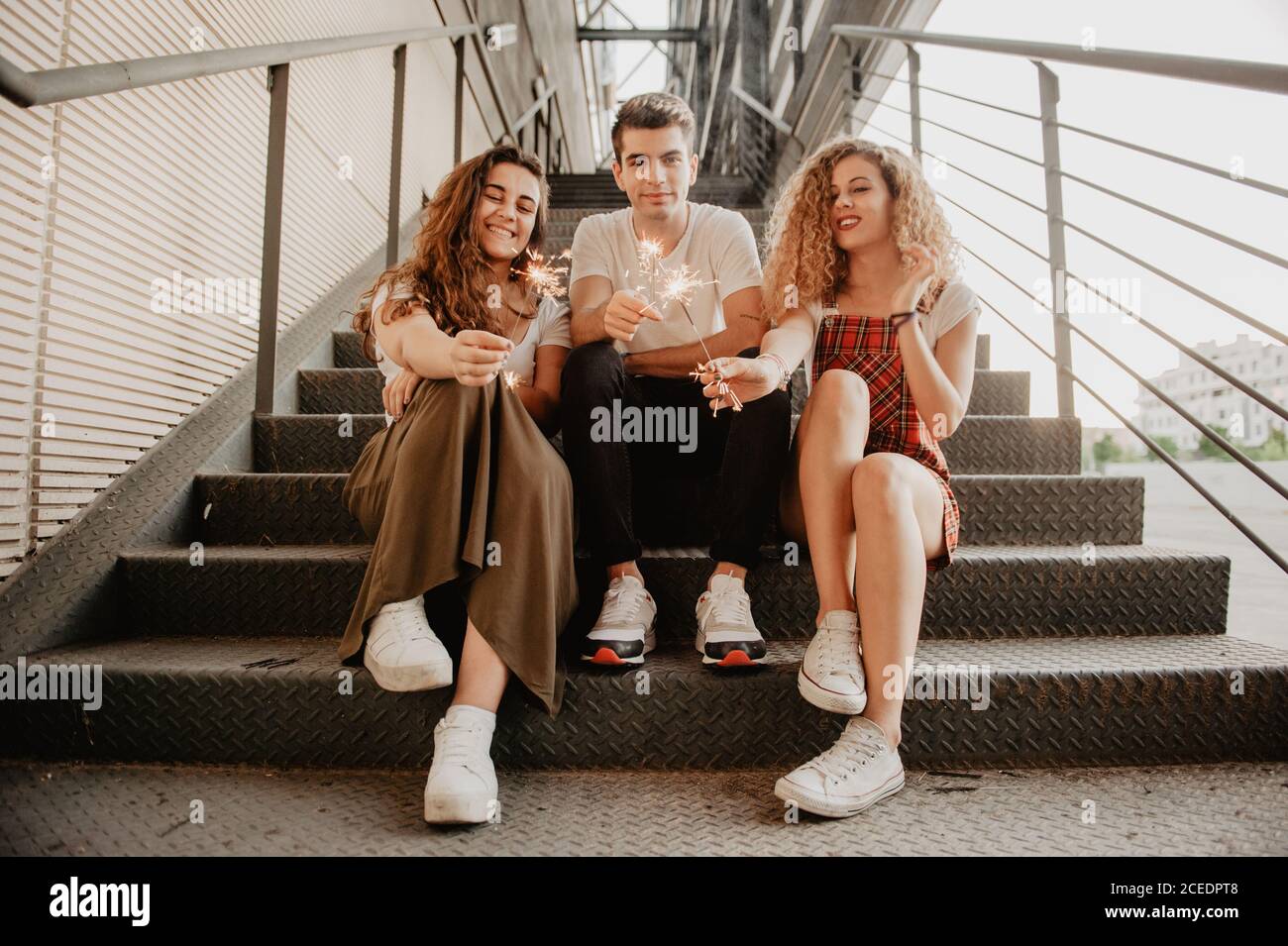 Friends with sparkles on steps Stock Photo - Alamy