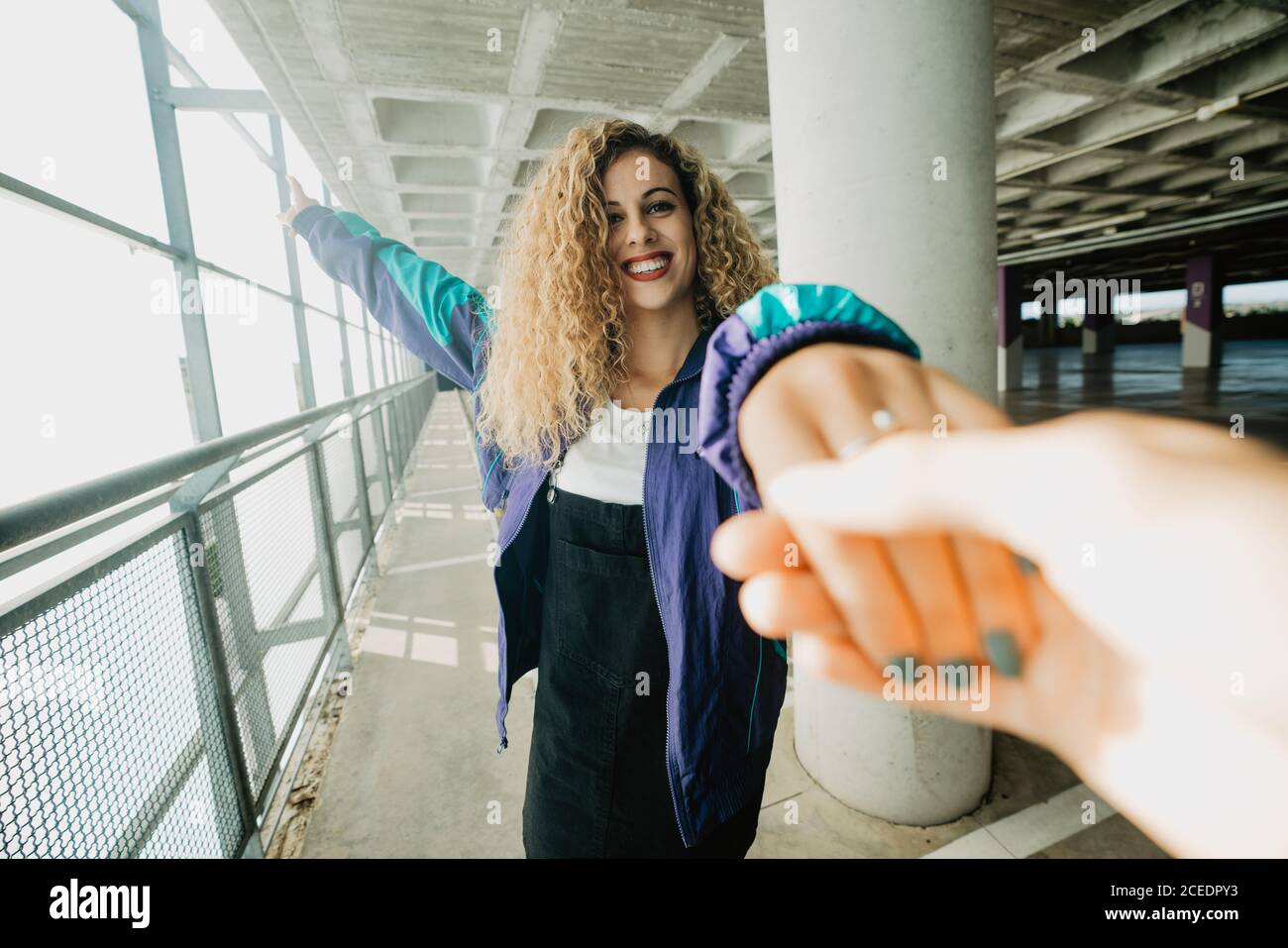 Cheerful Woman asking to follow her Stock Photo - Alamy