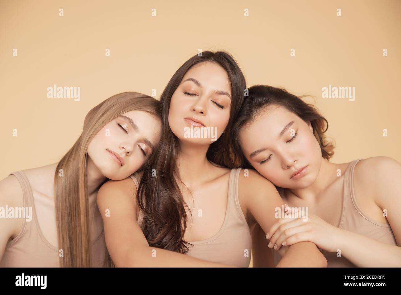 Group multiracial beauty smiling women with perfect face hug and ...