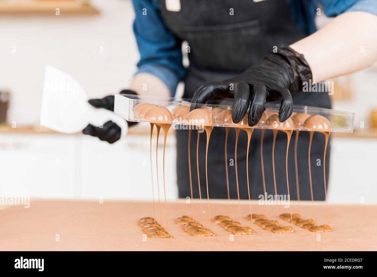 Chef or chocolatier making sweet chocolates home on background of ...