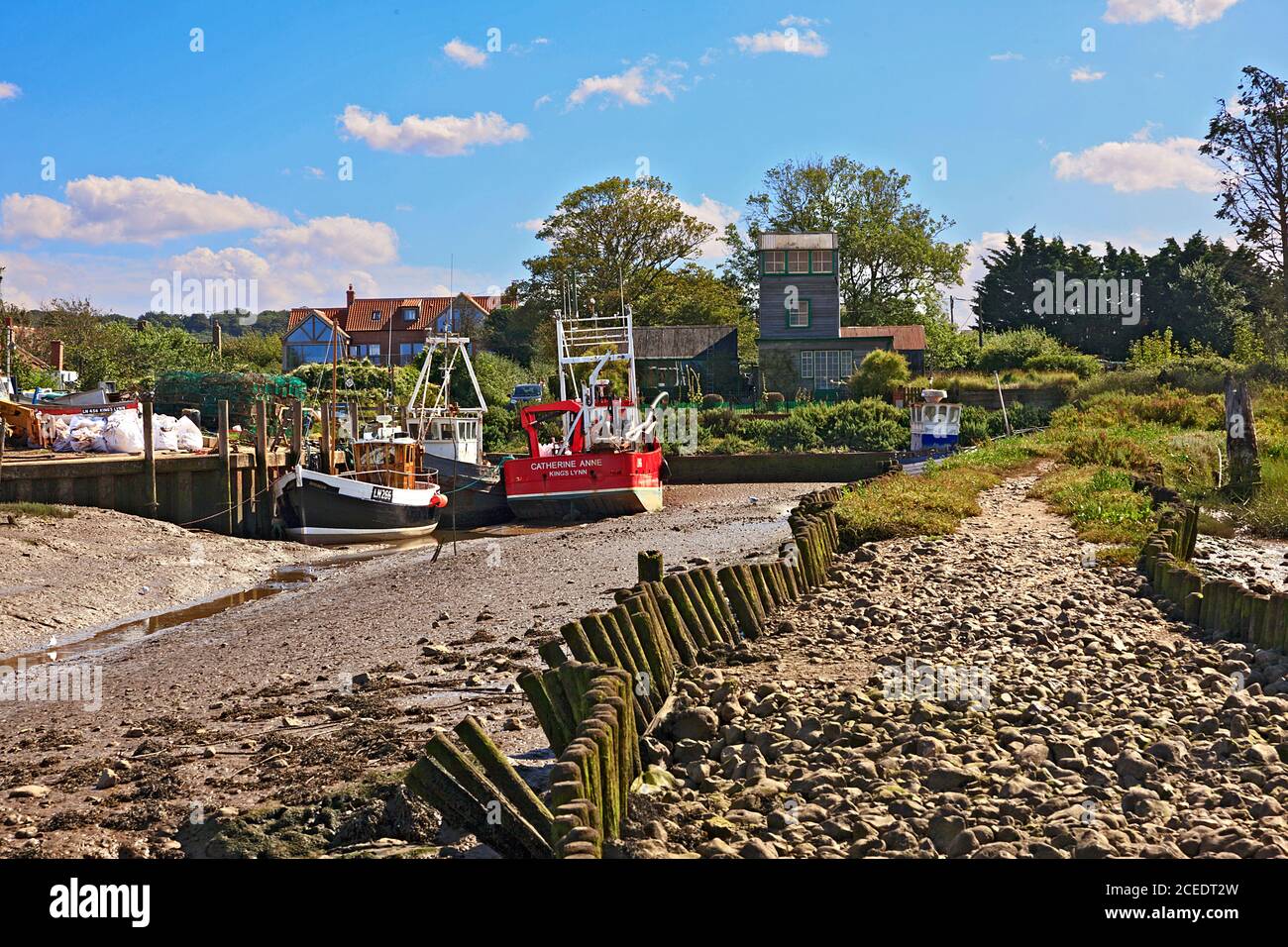 Low tide in the Harbour at Brancaster Staithe, Norfolk, UK Stock Photo ...