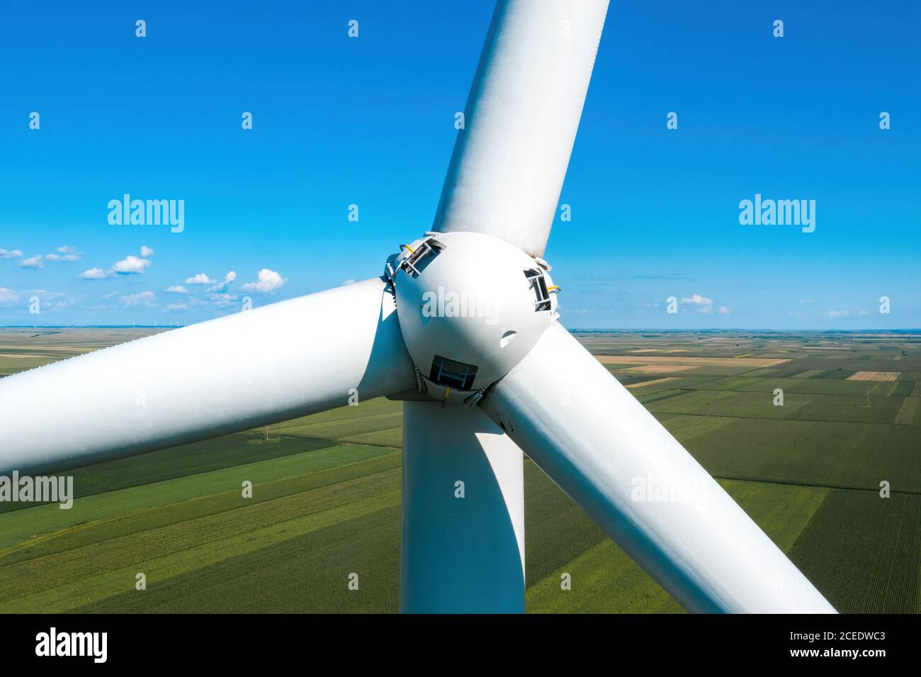 Aerial view of wind turbine rotor with blades on modern wind farm from ...