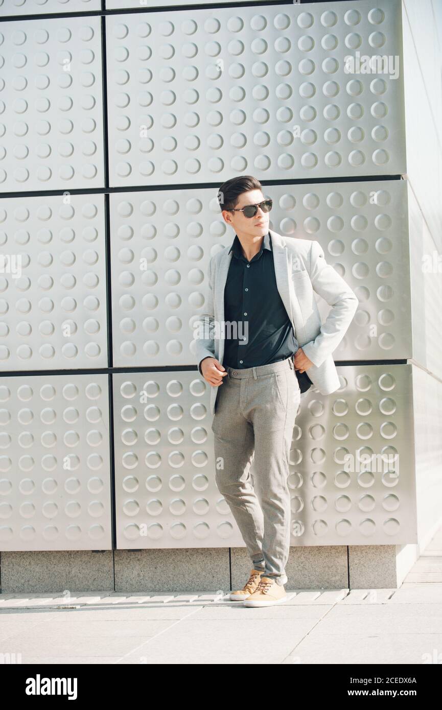 Confident man standing near building Stock Photo - Alamy