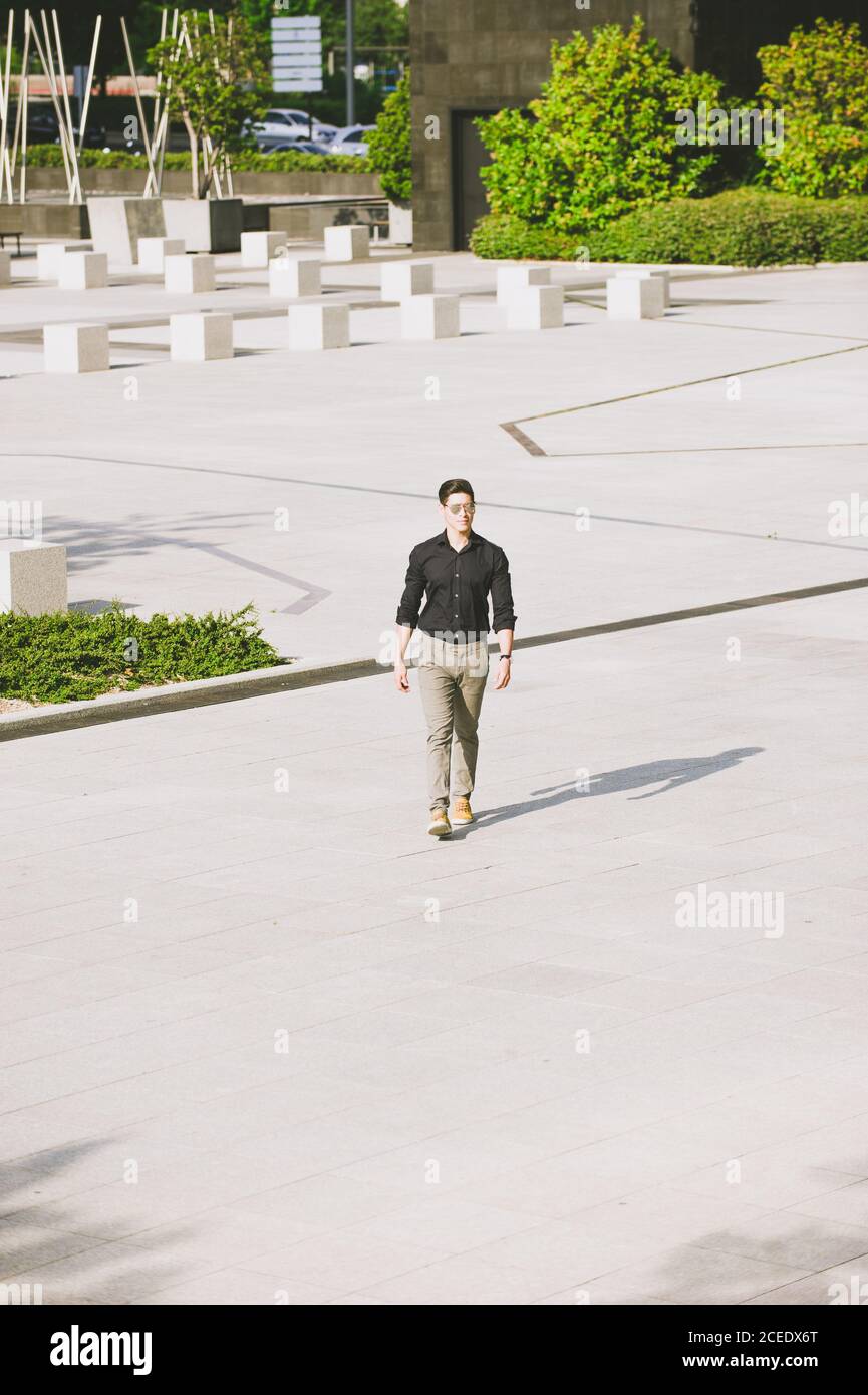 Relaxed man walking on street Stock Photo - Alamy