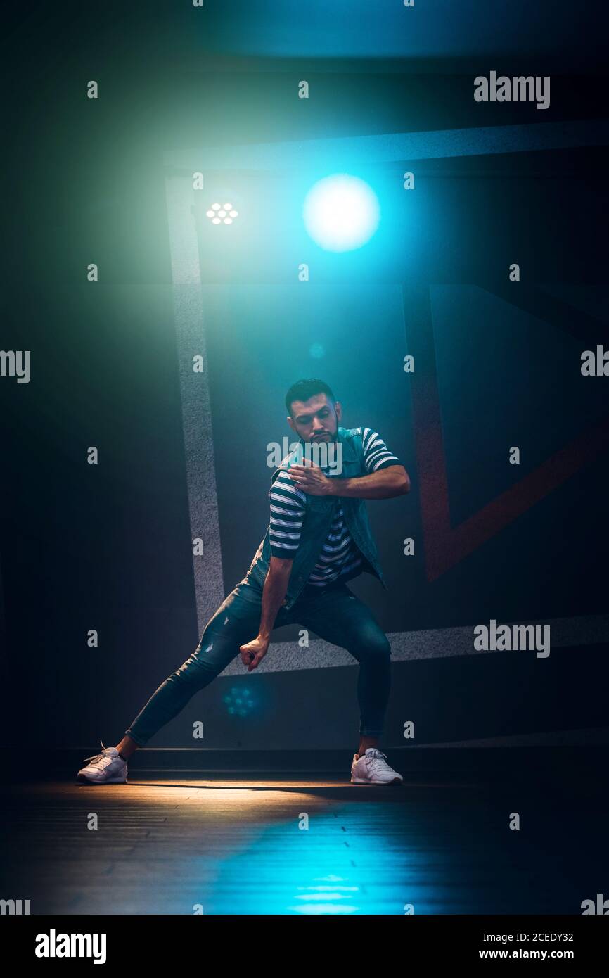 Handsome bearded man dancing in spotlight Stock Photo - Alamy