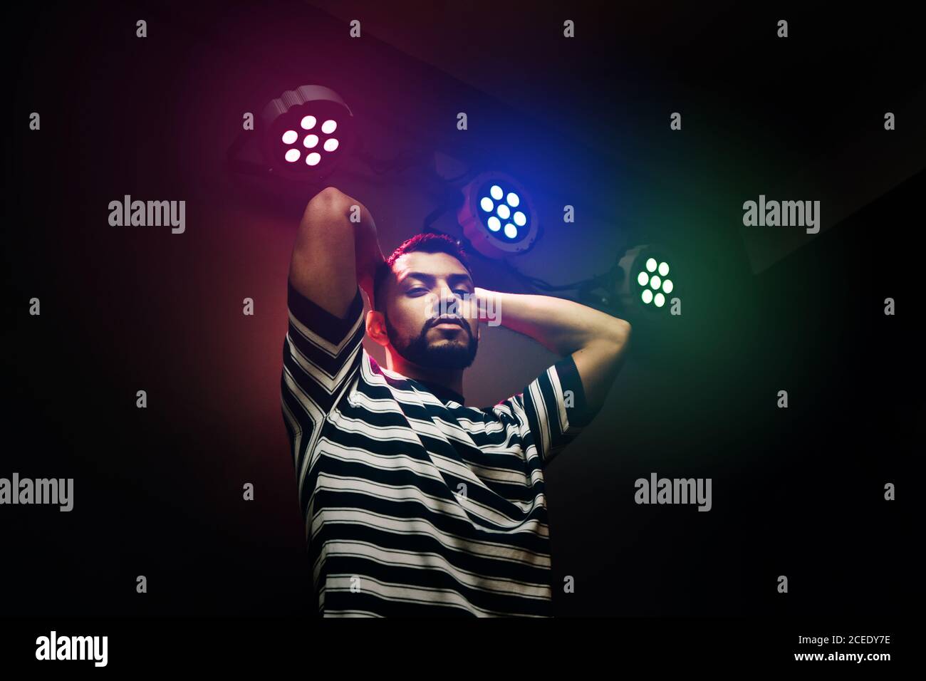 Handsome bearded man dancing in spotlight Stock Photo - Alamy
