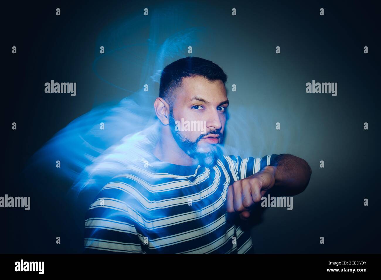 Handsome bearded man dancing in spotlight Stock Photo - Alamy