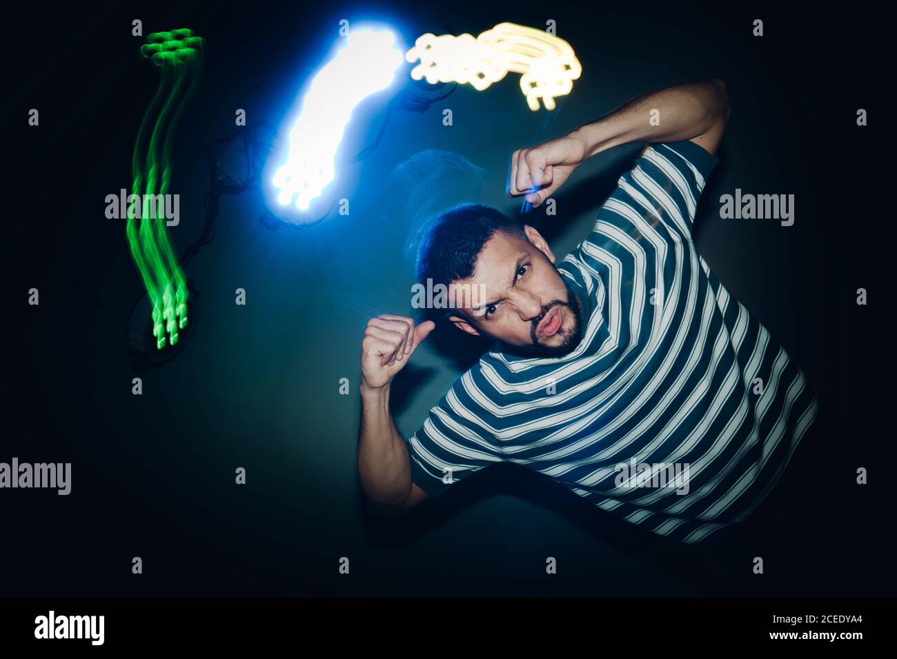 Handsome bearded man dancing in spotlight Stock Photo - Alamy