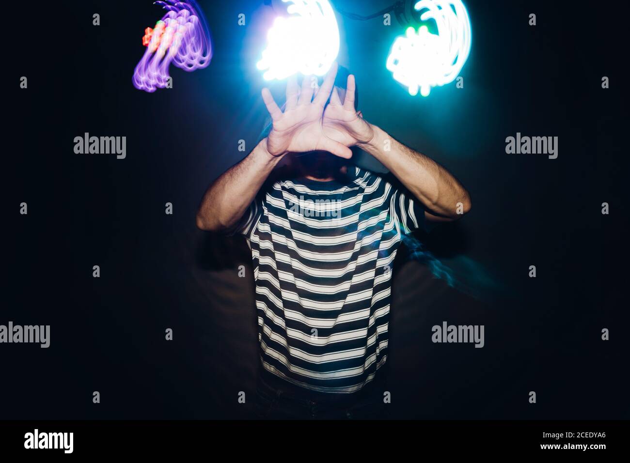 Handsome bearded man dancing in spotlight Stock Photo - Alamy