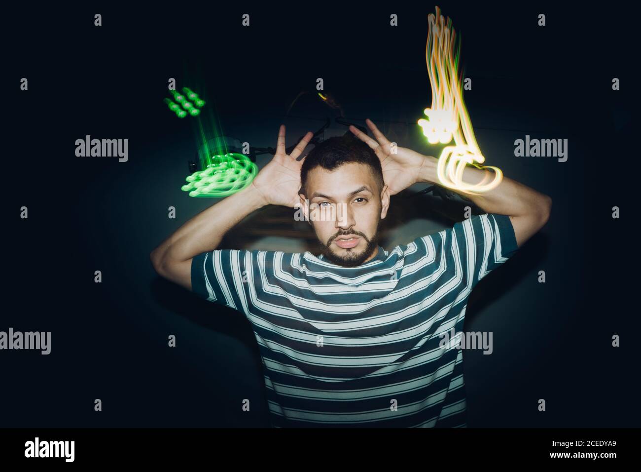 Handsome bearded man dancing in spotlight Stock Photo - Alamy