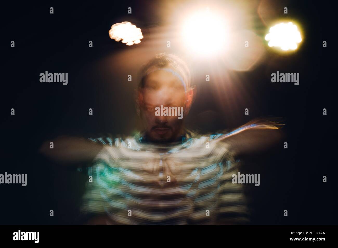 Handsome bearded man dancing in spotlight Stock Photo - Alamy