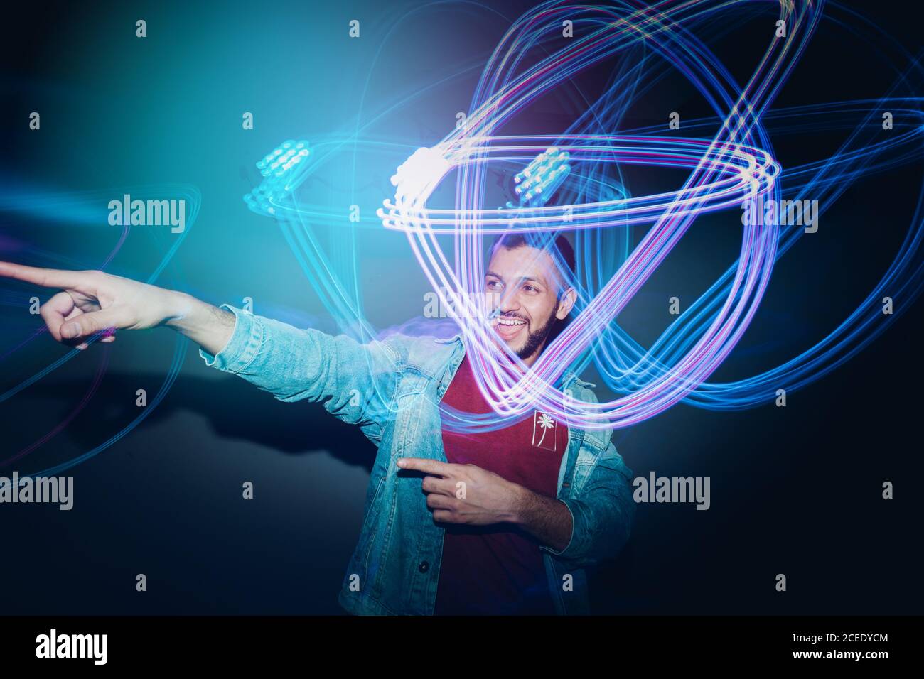 Handsome bearded man dancing in spotlight Stock Photo - Alamy