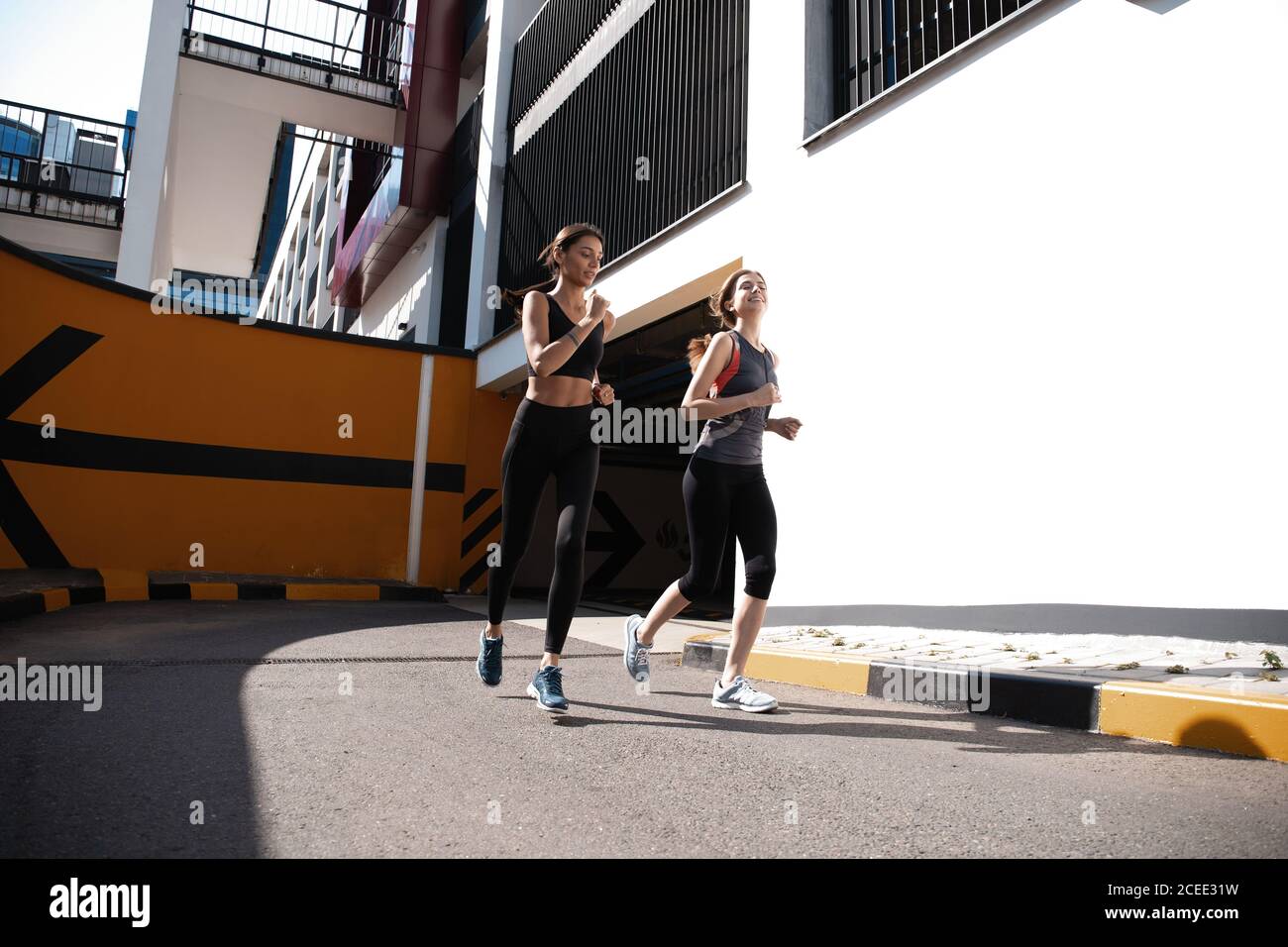 Fit women in sport clothing jogging outdoors and living a healthy ...