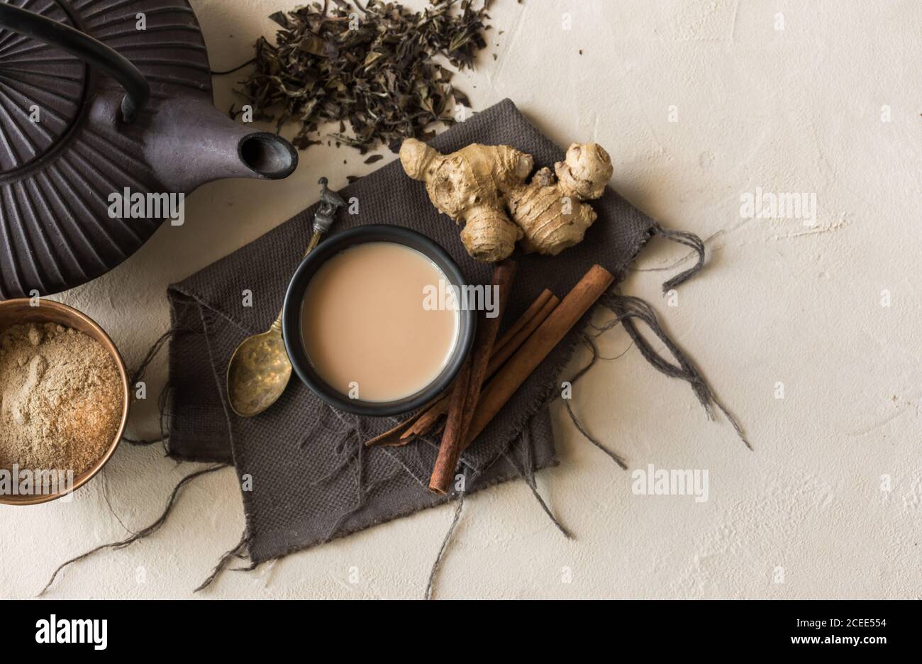 Oriental cup of tea Chai, Its ingredients with milk, cinnamon, ginger ...