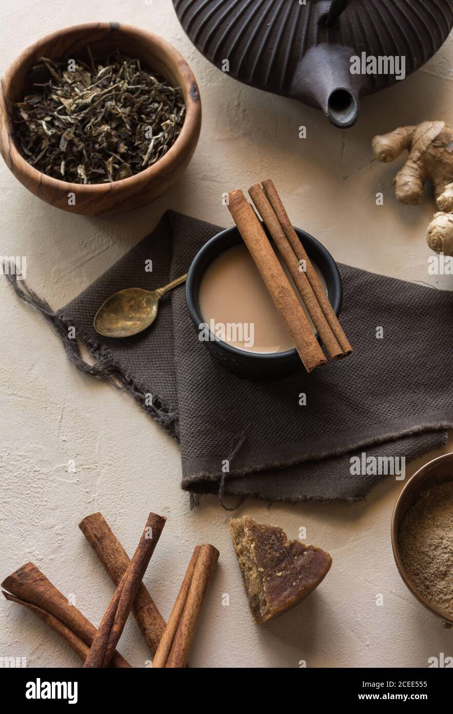 Oriental cup of tea Chai, Its ingredients with milk, cinnamon, ginger ...