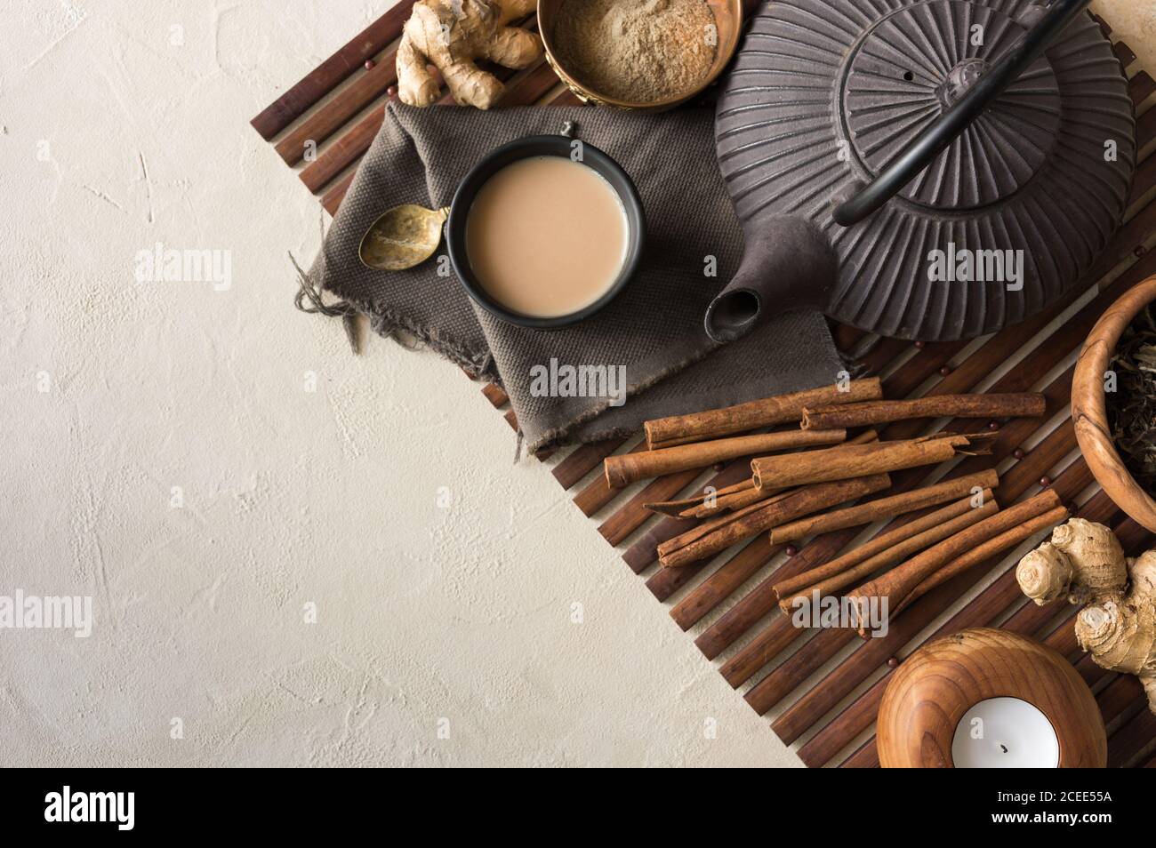 Oriental cup of tea Chai, Its ingredients with milk, cinnamon, ginger ...